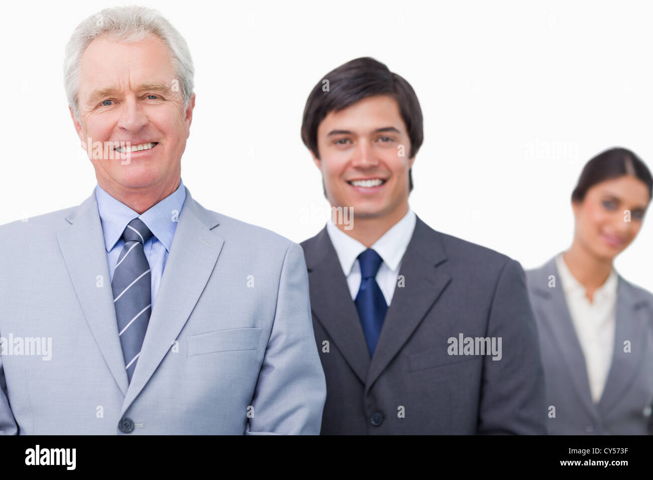 Smiling mature salesman with his employees Stock Photo - Alamy