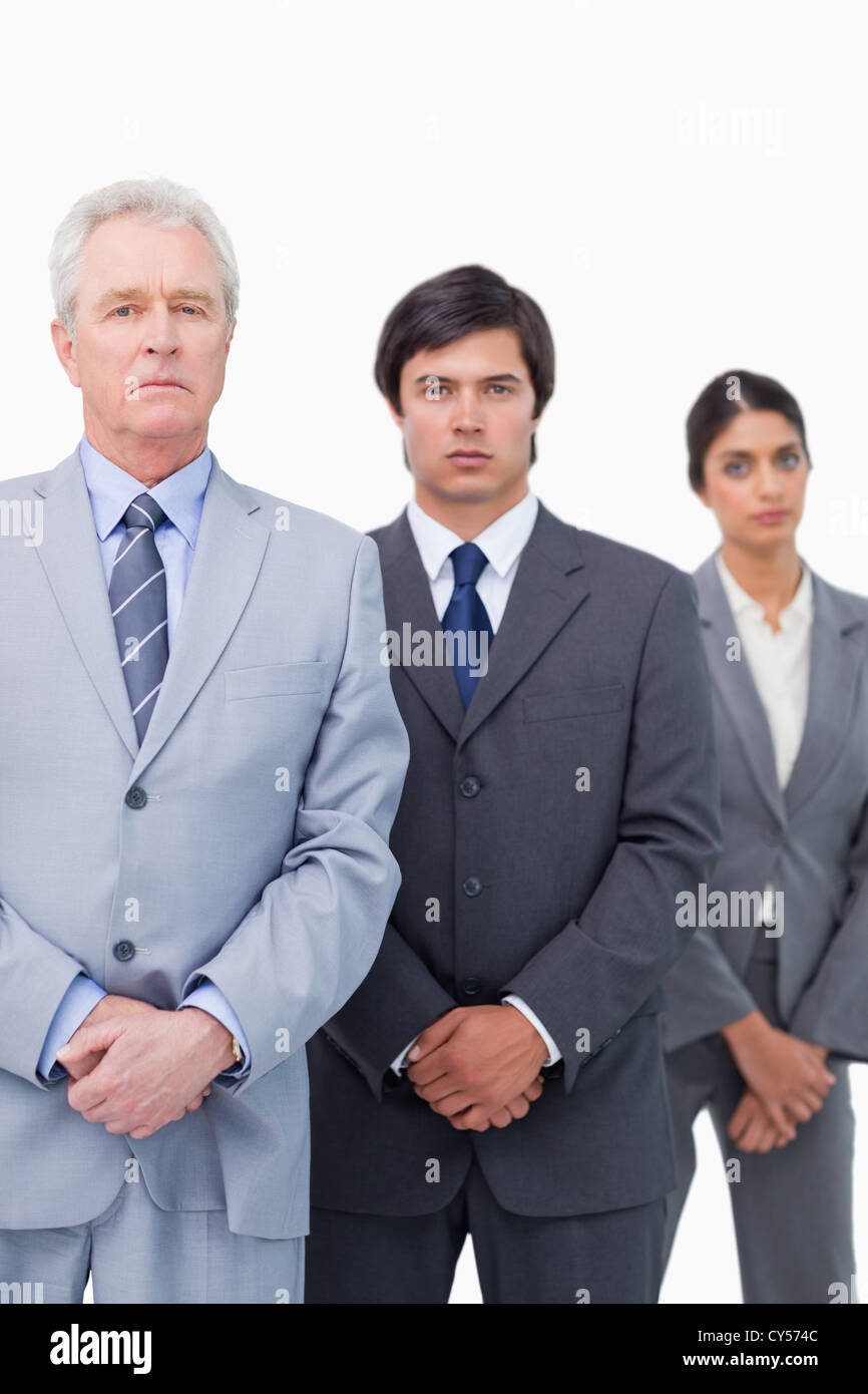 Mature tradesman standing with his employees Stock Photo - Alamy