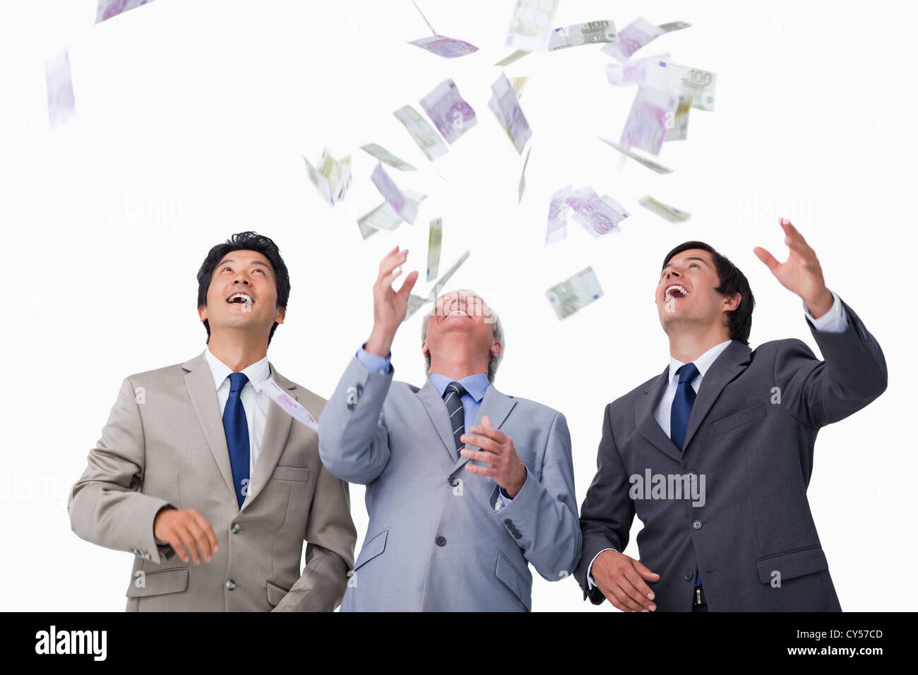 Bank notes raining down on business team Stock Photo - Alamy