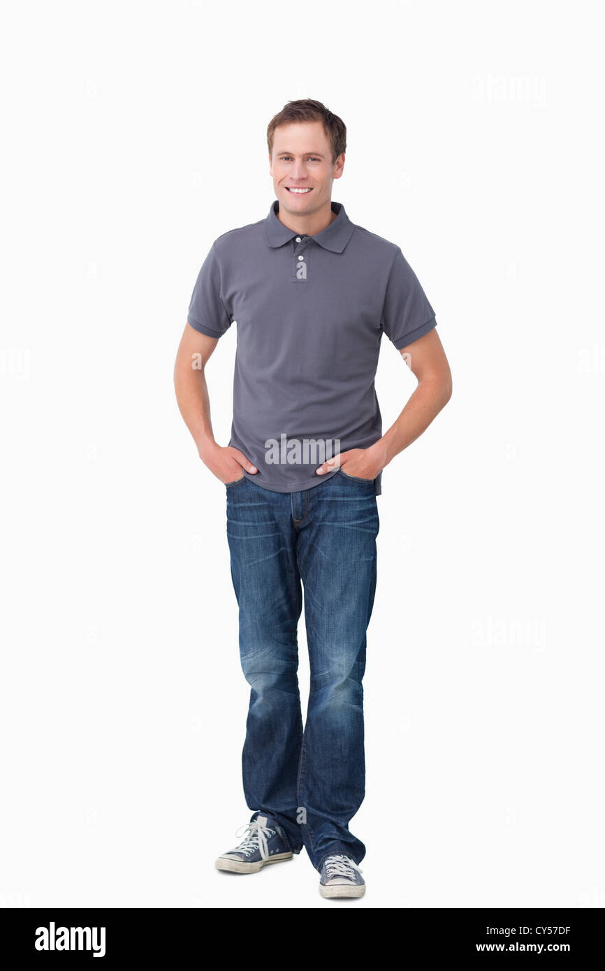 Smiling young man with hands in his pockets Stock Photo - Alamy