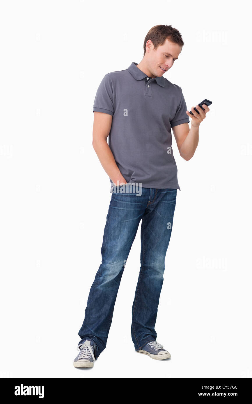 Young man typing text message on his cellphone Stock Photo - Alamy