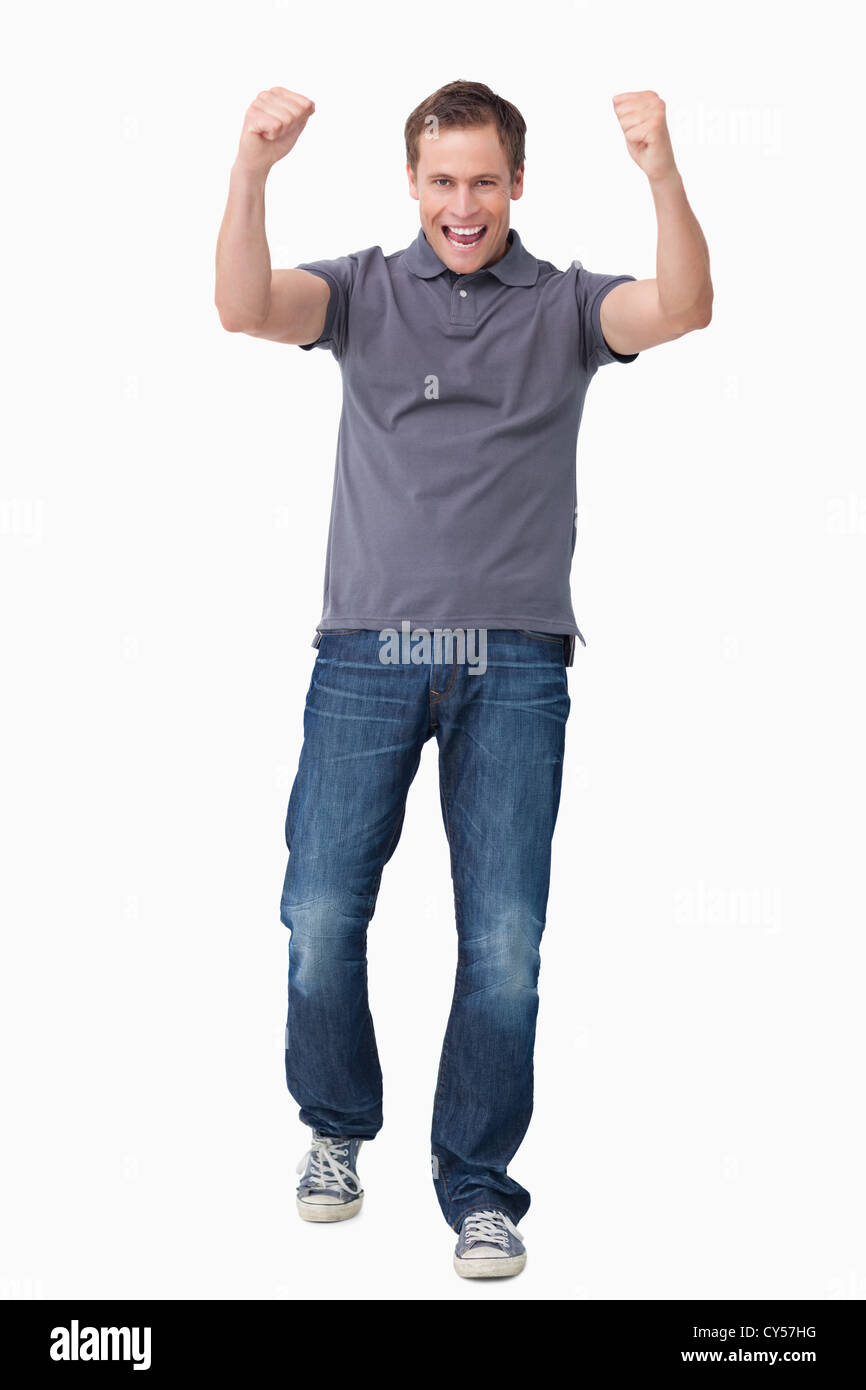 Cheering young man Stock Photo - Alamy