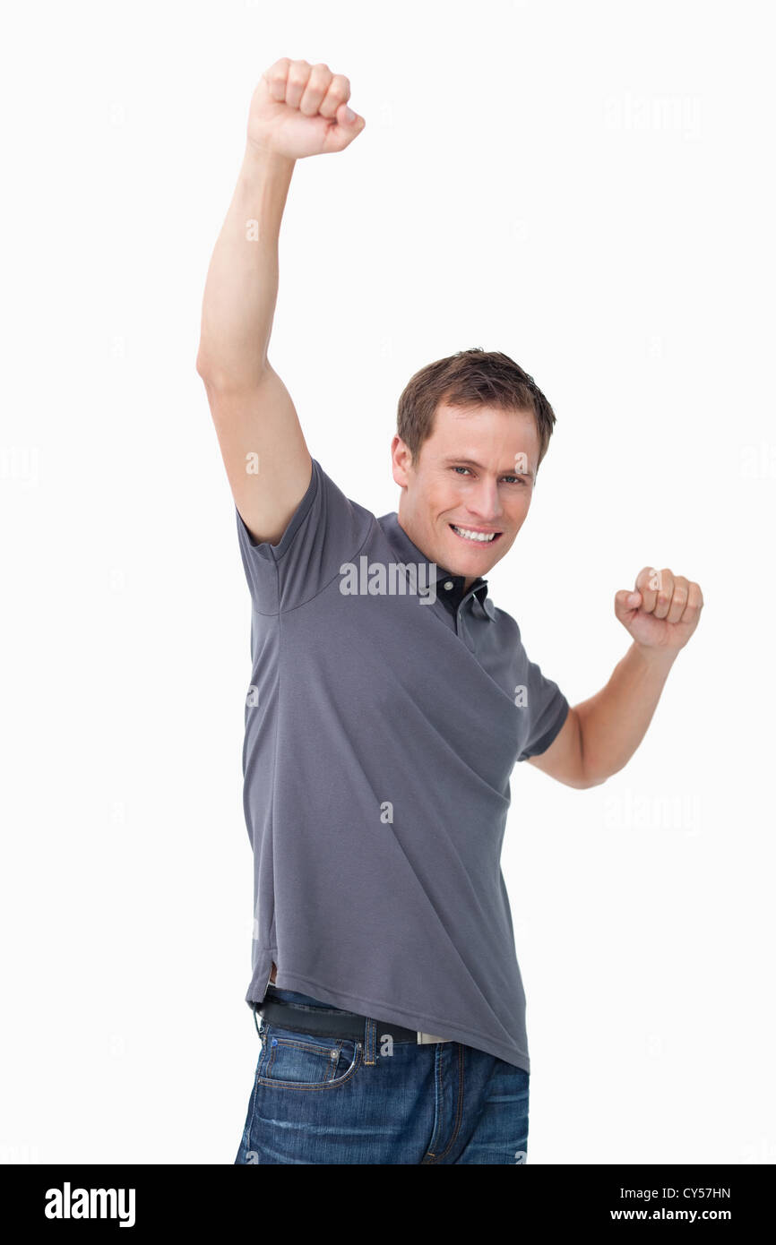 Victorious young man raising fist Stock Photo - Alamy Victorious young man raising fist Stock Photo - Alamy