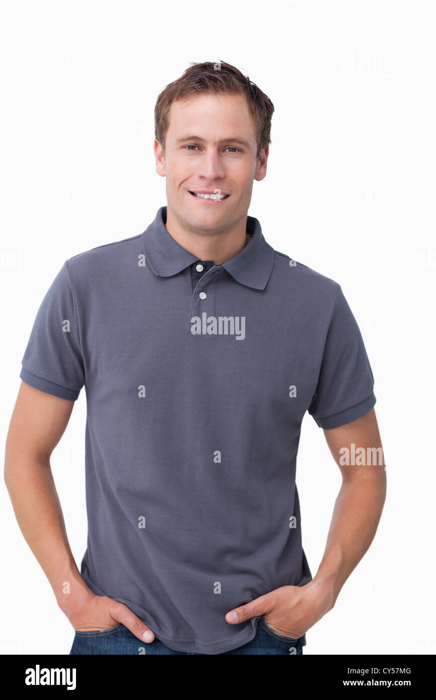 Smiling young male with hands in his pockets Stock Photo - Alamy