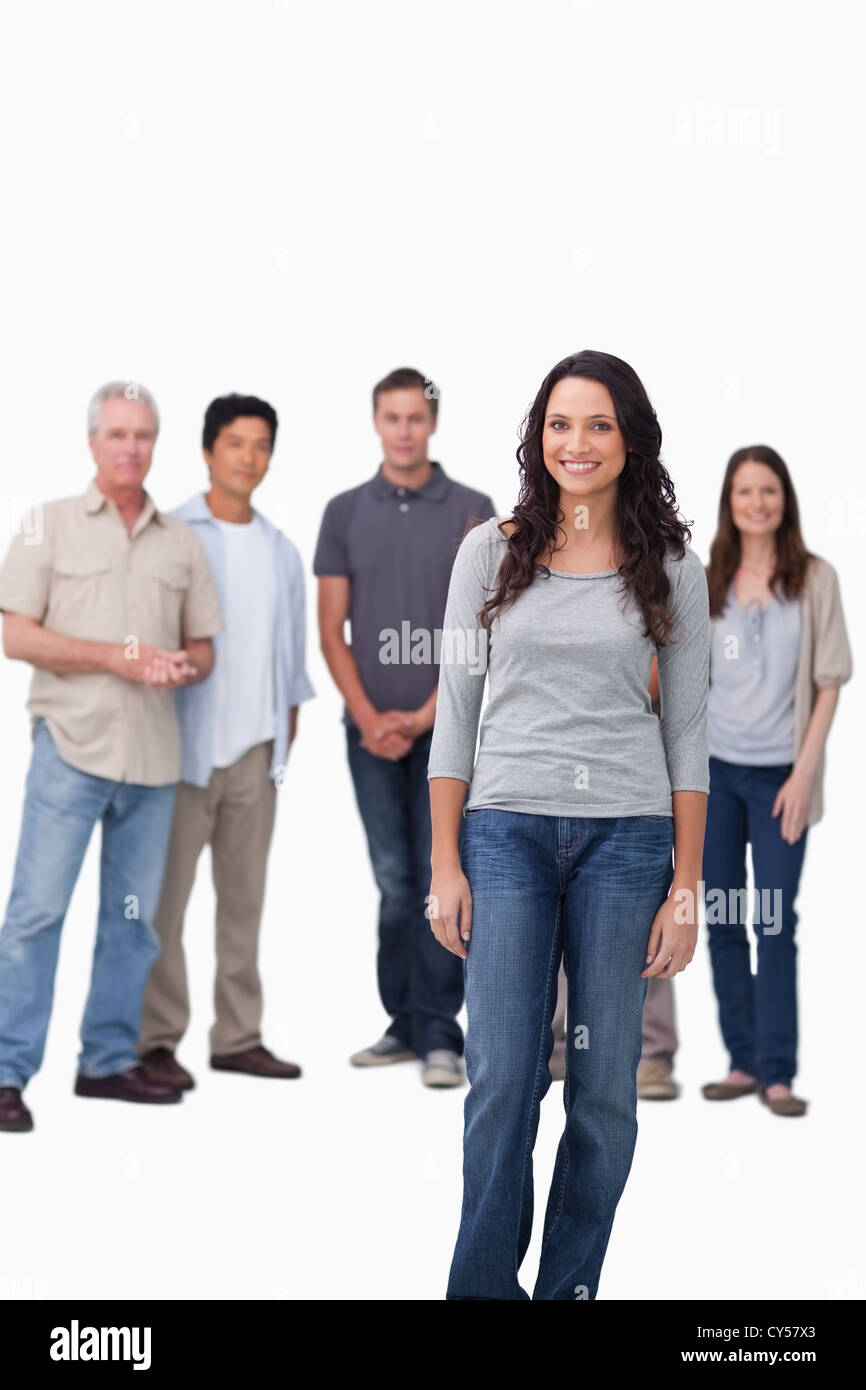 Smiling woman standing with friends behind her Stock Photo - Alamy