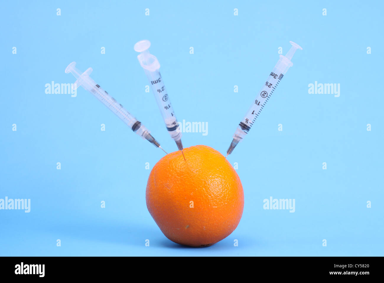 Orange injected with syringes Stock Photo - Alamy