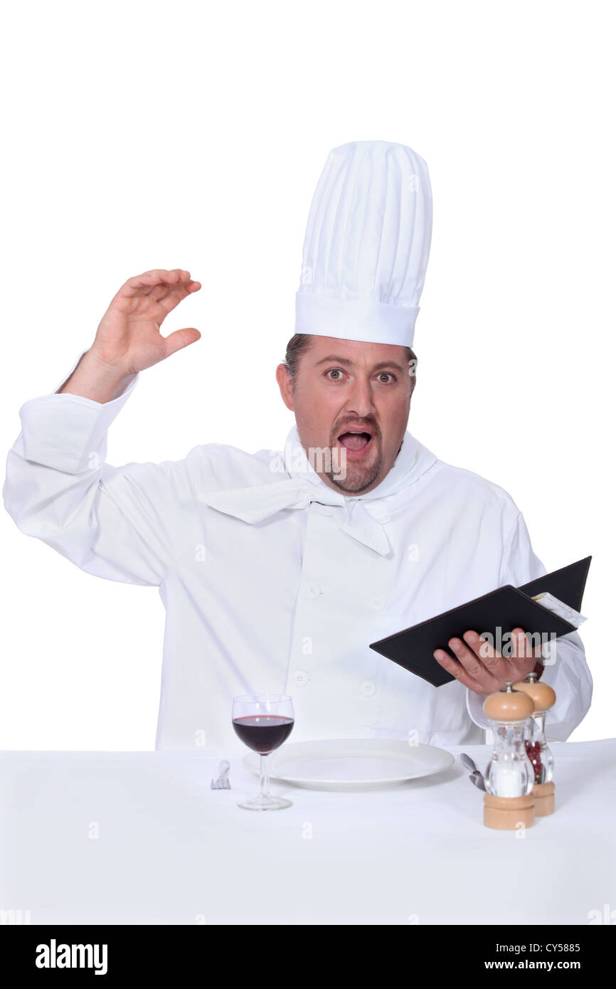 Chef with a menu Stock Photo - Alamy