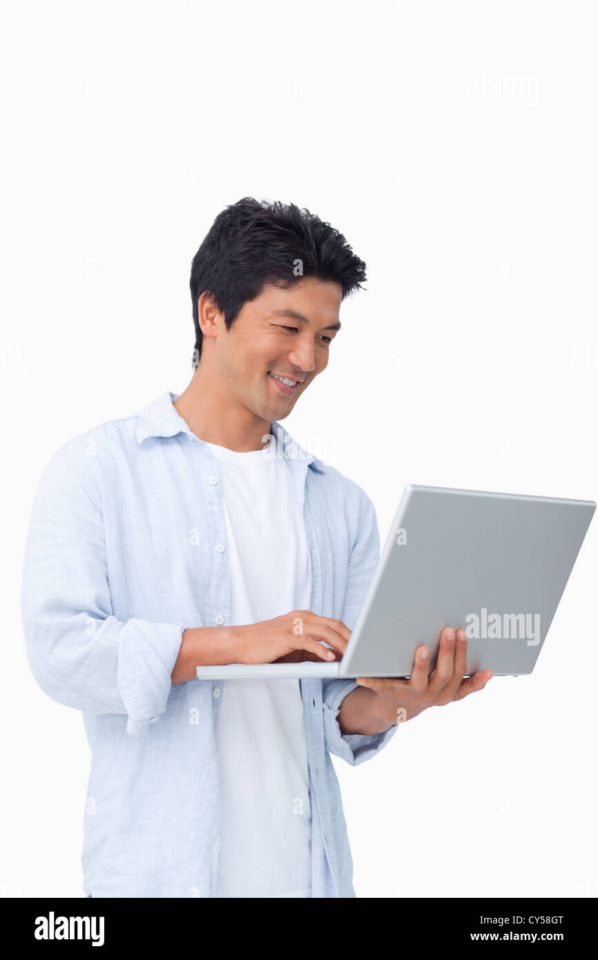 Smiling male on his laptop Stock Photo - Alamy