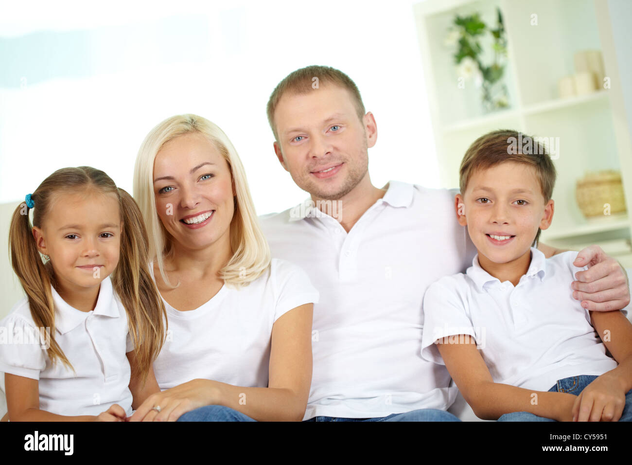 Portrait of happy family with two children smiling at camera Stock ...