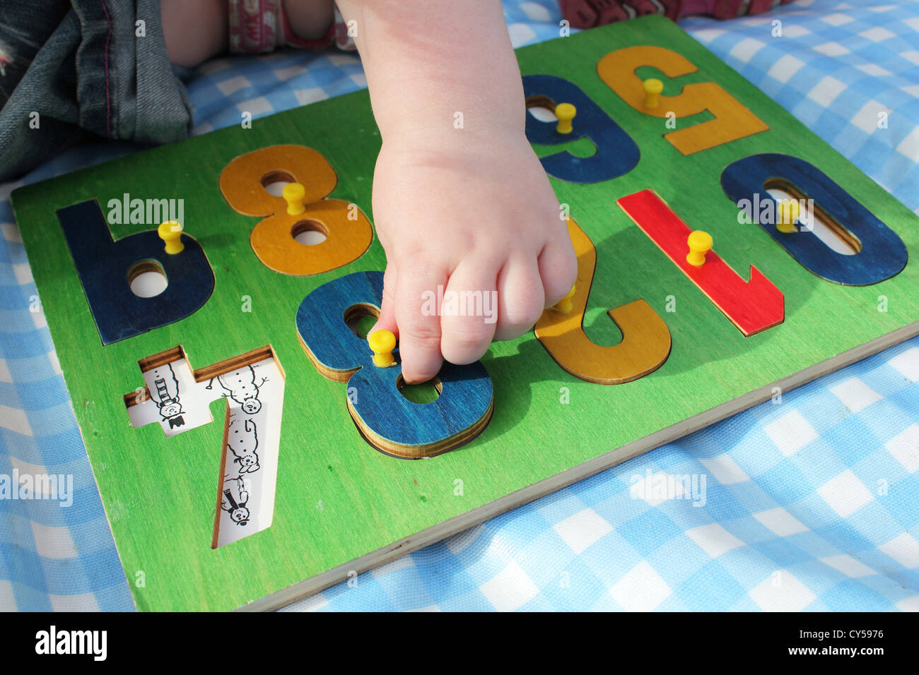 Child playing with number puzzle Stock Photo - Alamy