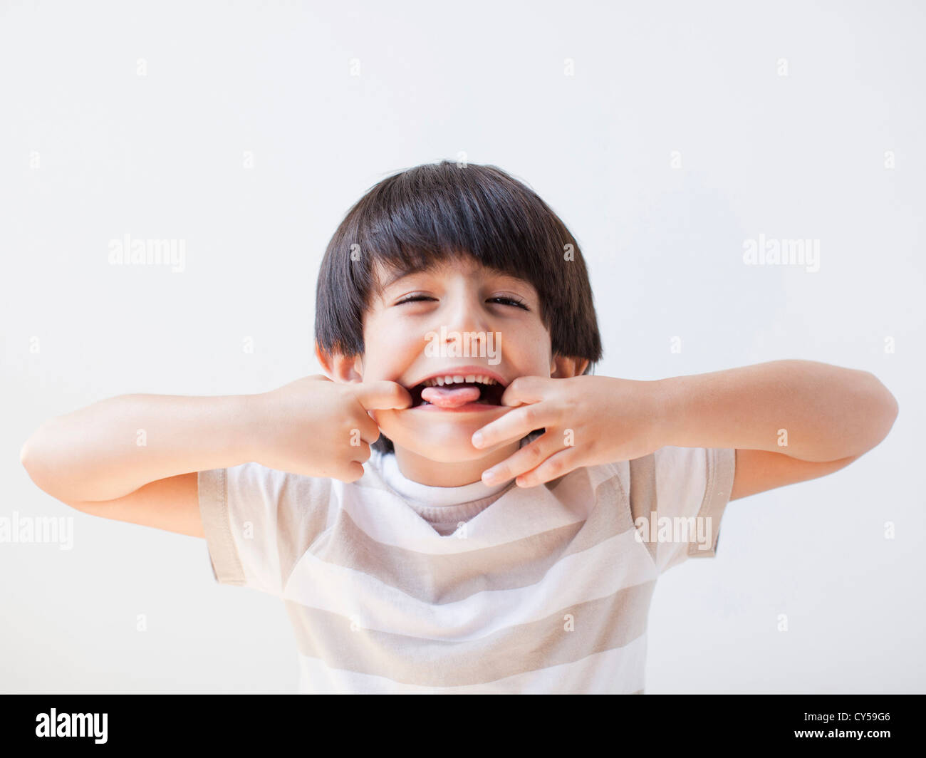 Studio Shot of young boy making grimace Stock Photo - Alamy