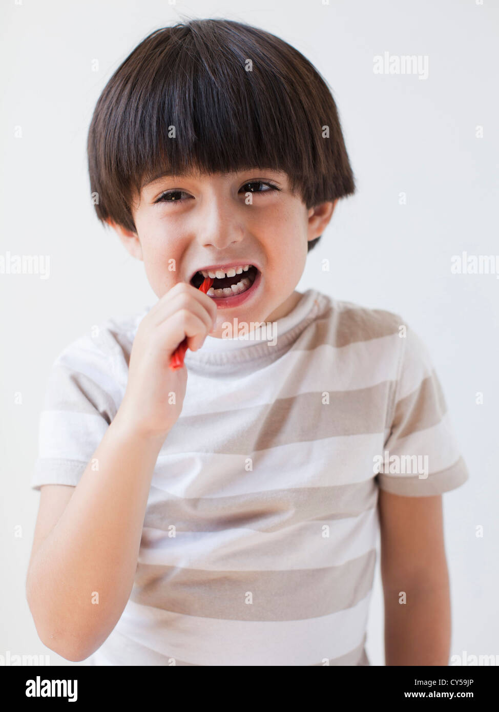 Studio Shot of young boy eating candy Stock Photo - Alamy