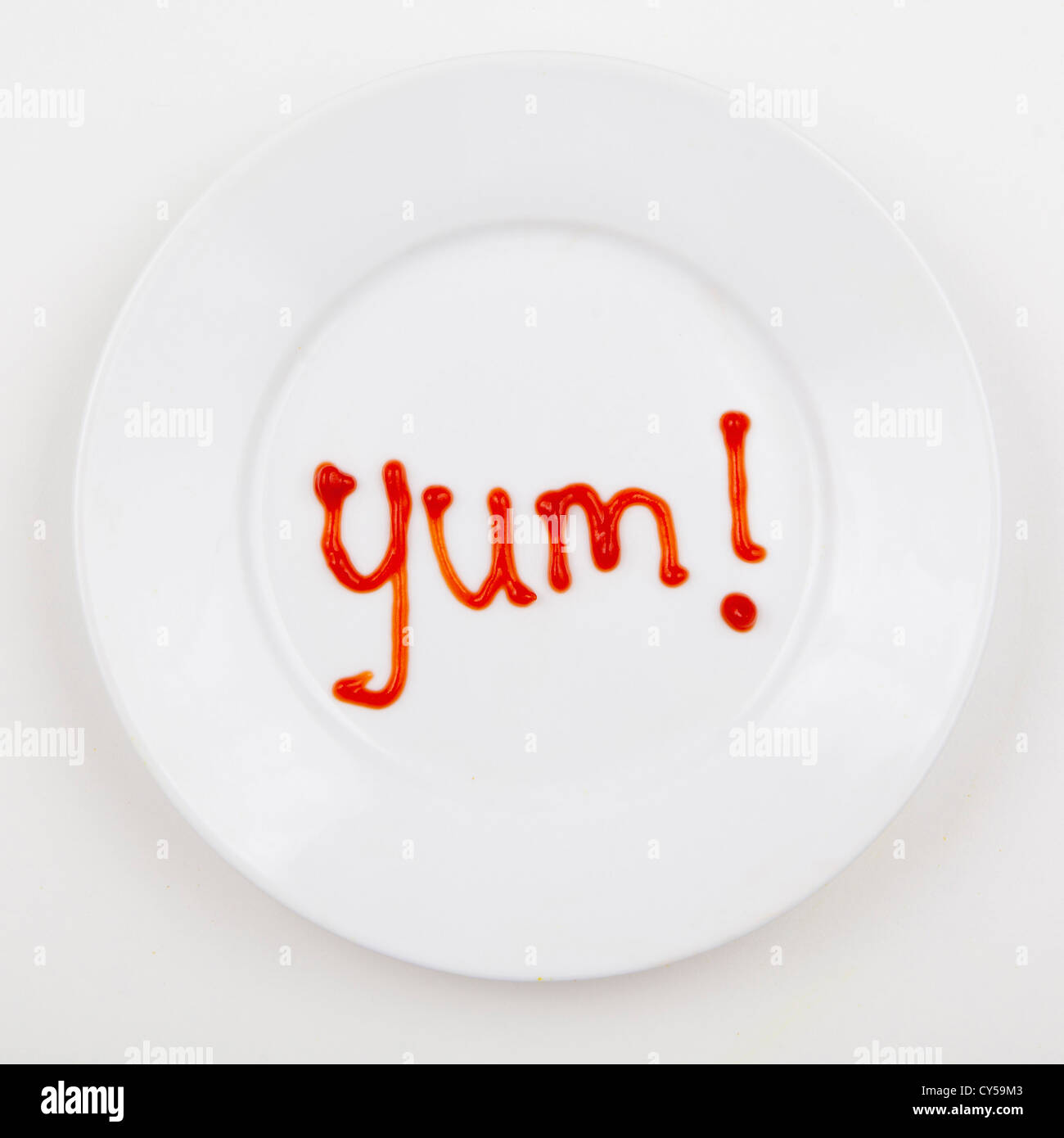 Word YUM written with ketchup Stock Photo - Alamy