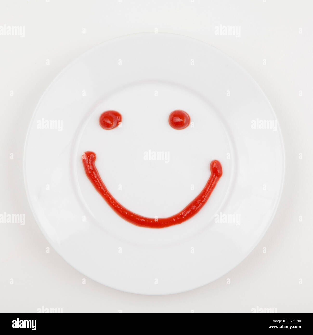 Plate with smiley face made of ketchup Stock Photo - Alamy