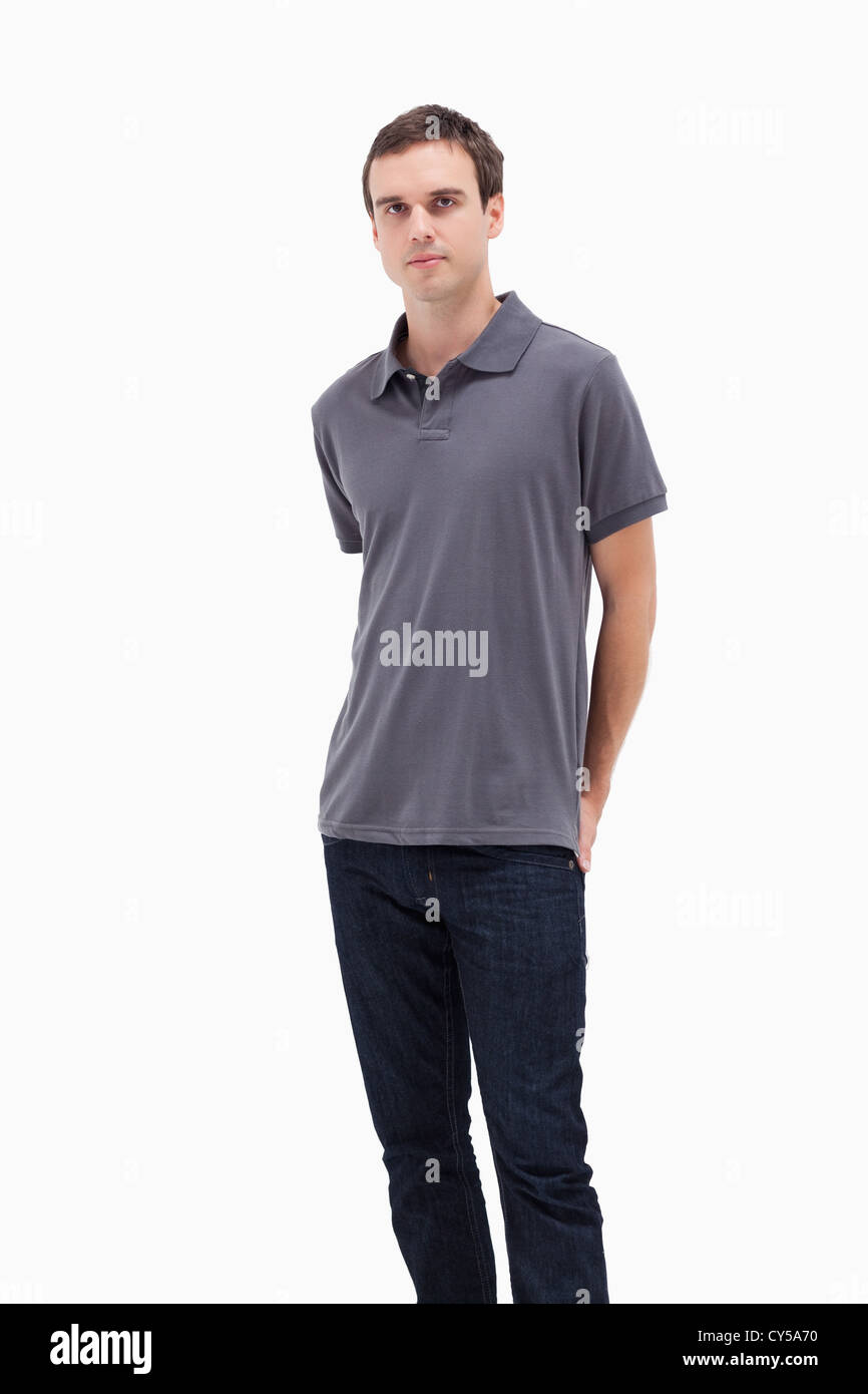 Standing man with his hands behind his back Stock Photo - Alamy