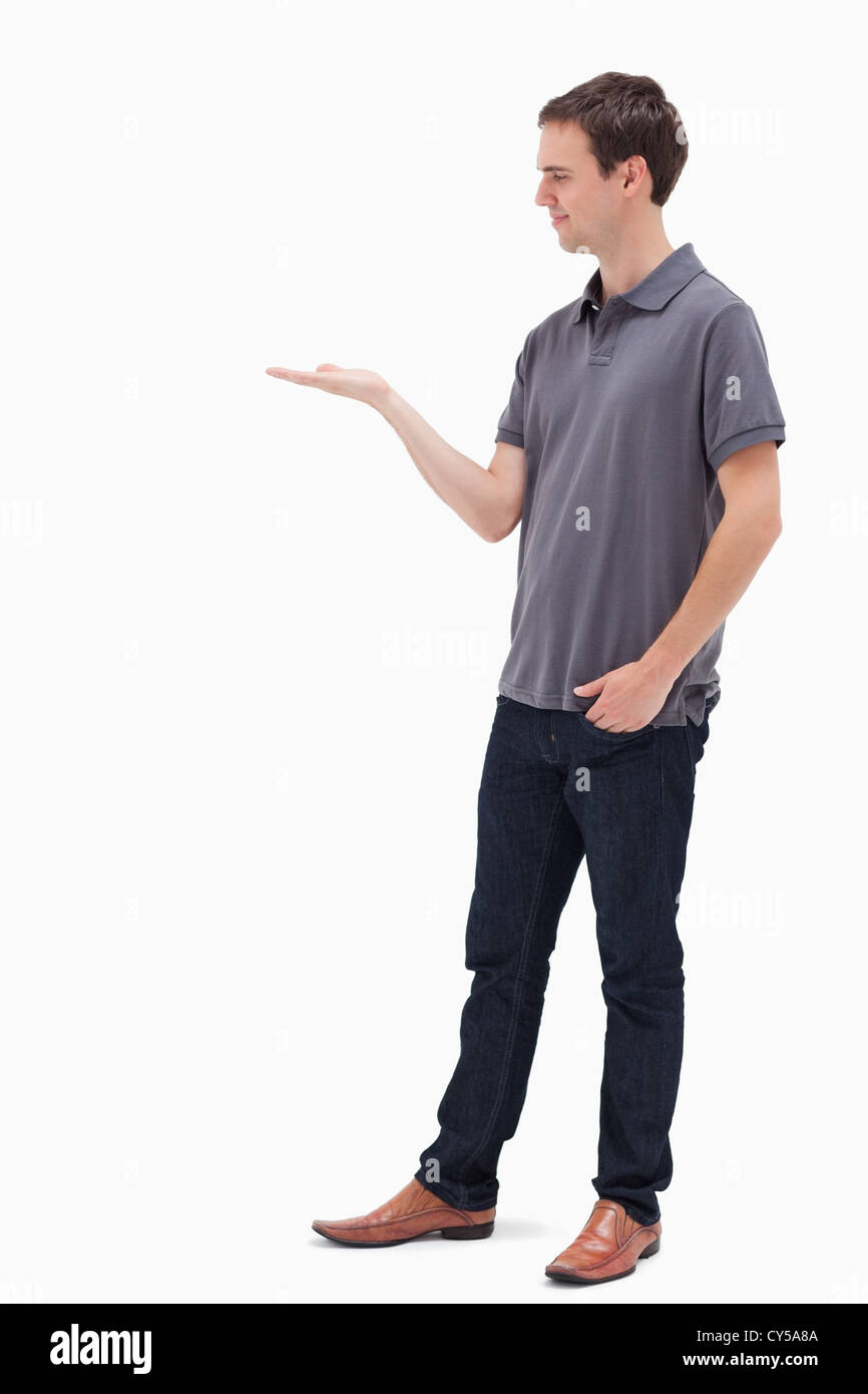 Standing man holding his palm out Stock Photo - Alamy