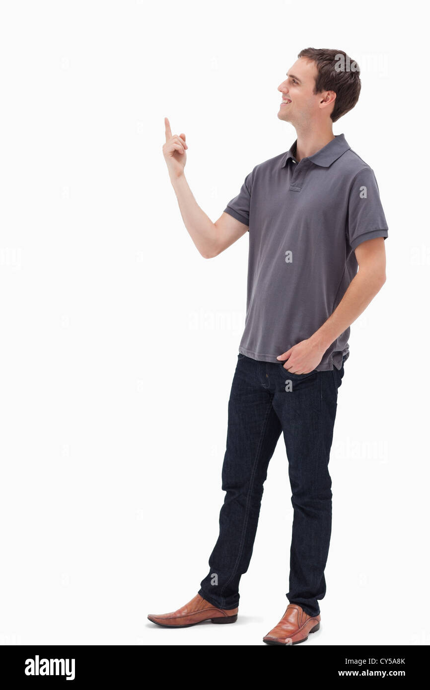 Man smiling while standing and pointing up Stock Photo - Alamy