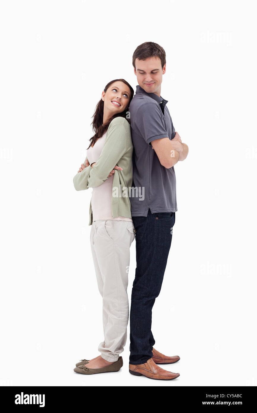 Couple standing back to back looking each other Stock Photo - Alamy