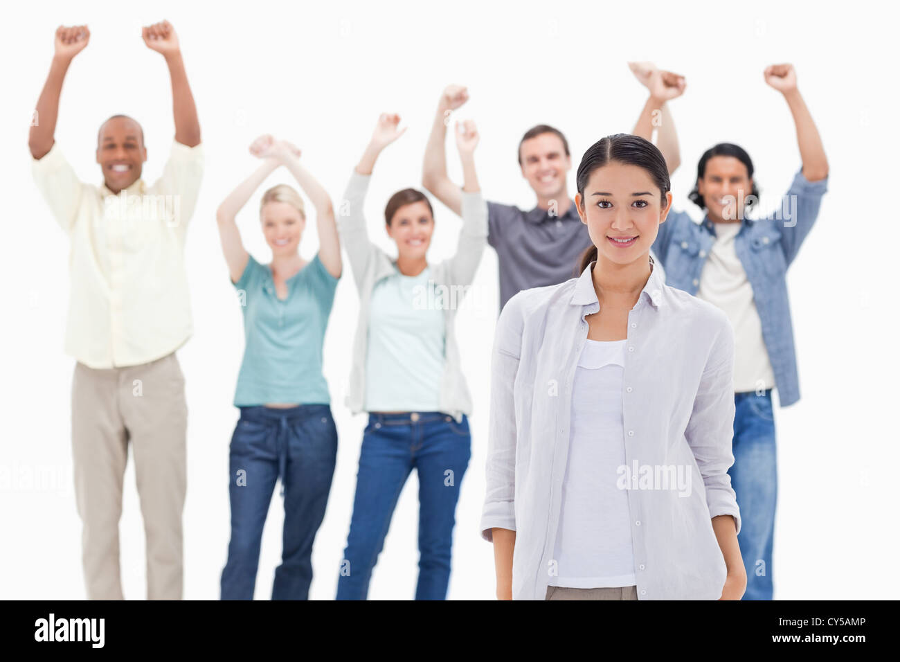 Woman with people raising their arms in background Stock Photo - Alamy