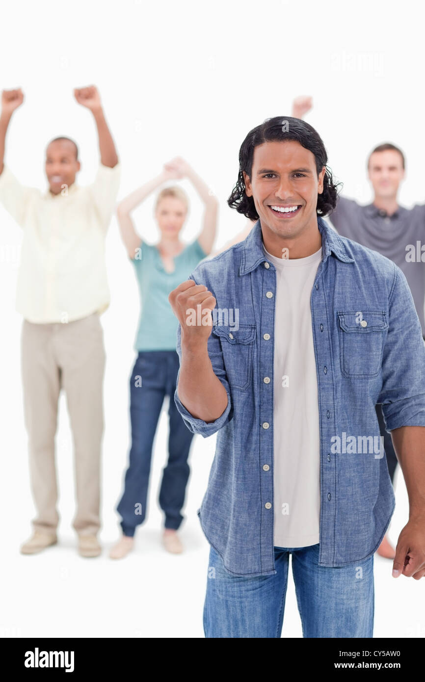 Man clenching his hand with people standing behind him Stock Photo - Alamy