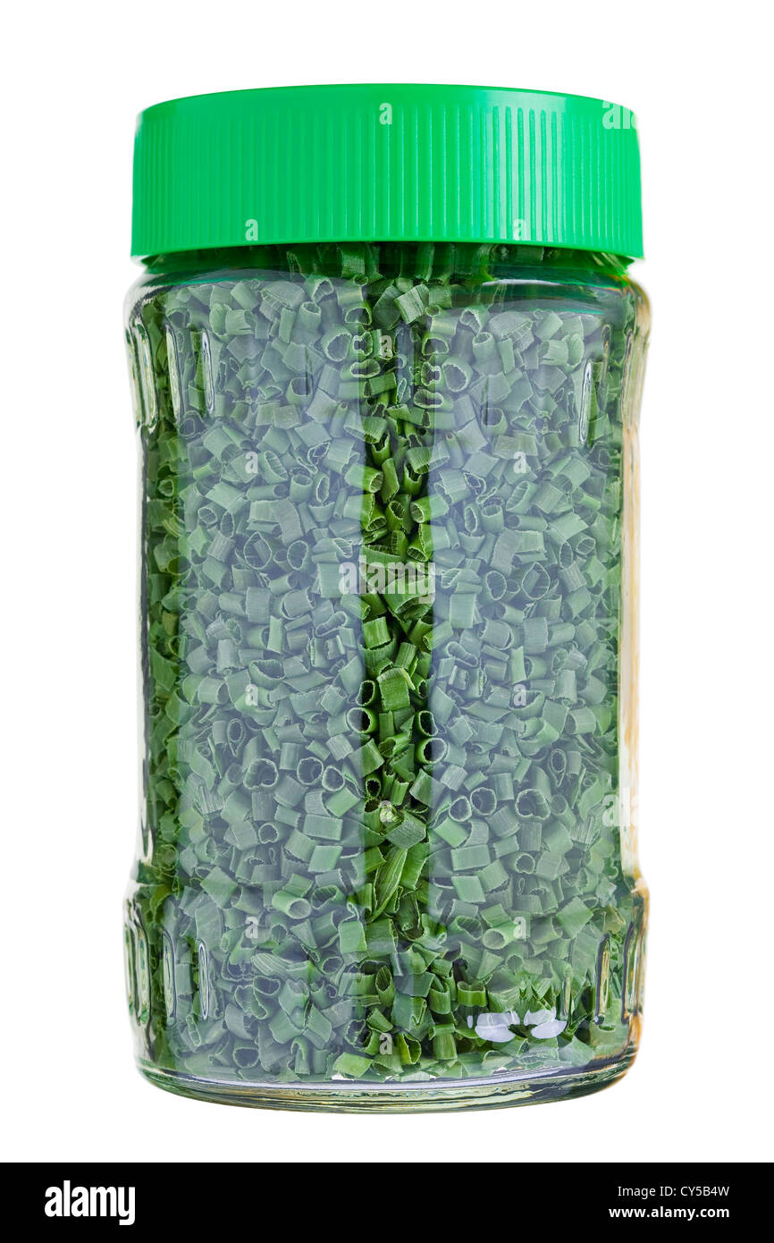 Close up of a small jar with dry chives, isolated on white background ...