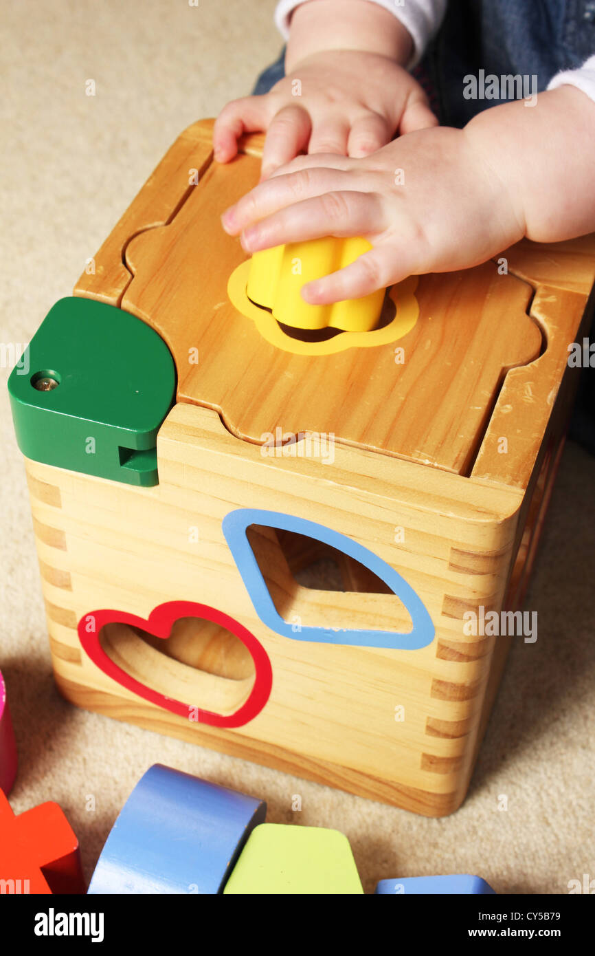Child playing with shape sorter Stock Photo - Alamy