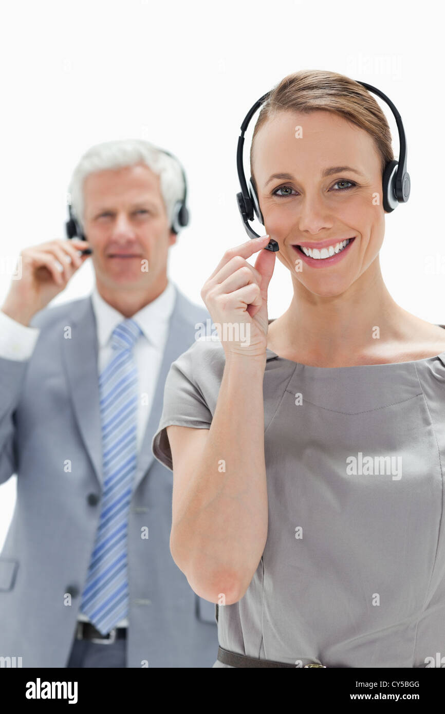 Smiling woman wearing a headset with a man Stock Photo - Alamy