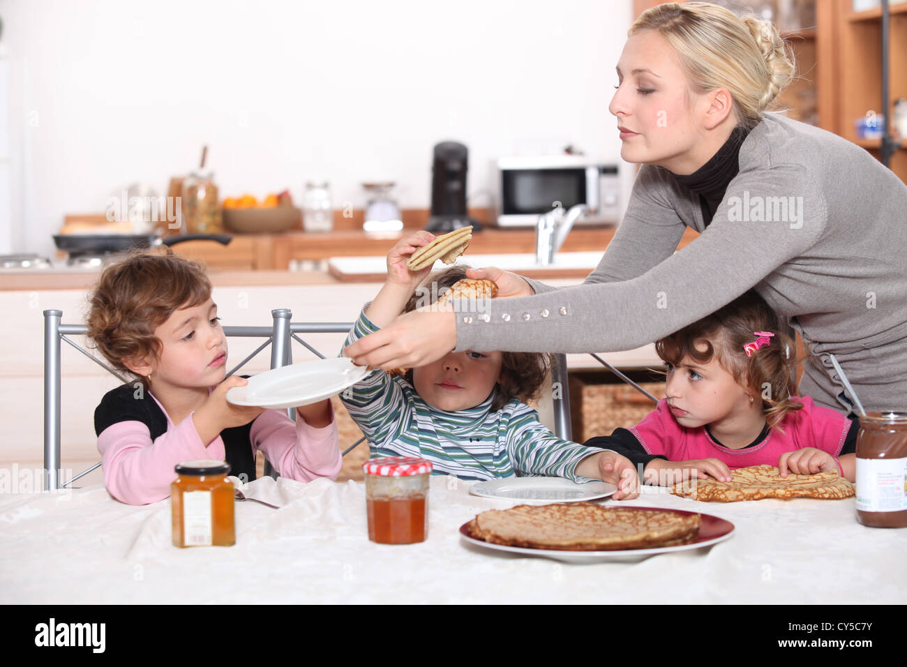 Kids having breakfast at home Stock Photo - Alamy