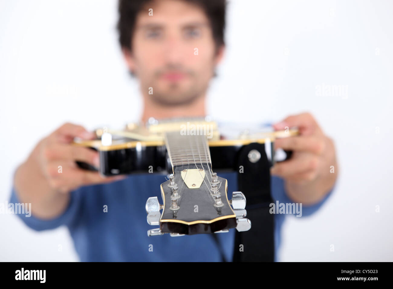 Man holding an electric guitar Stock Photo - Alamy