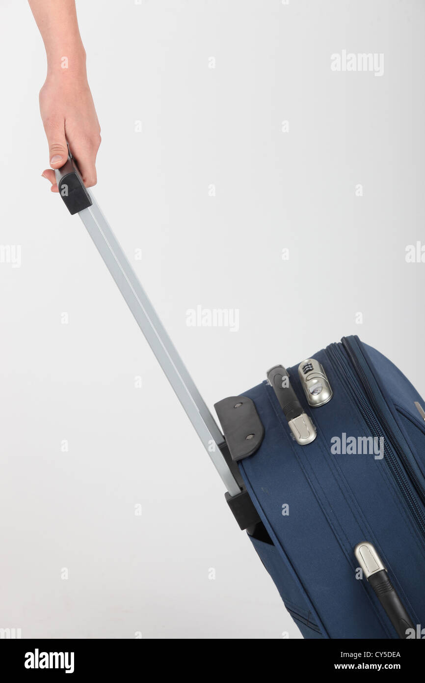 Suitcase being pulled along Stock Photo - Alamy
