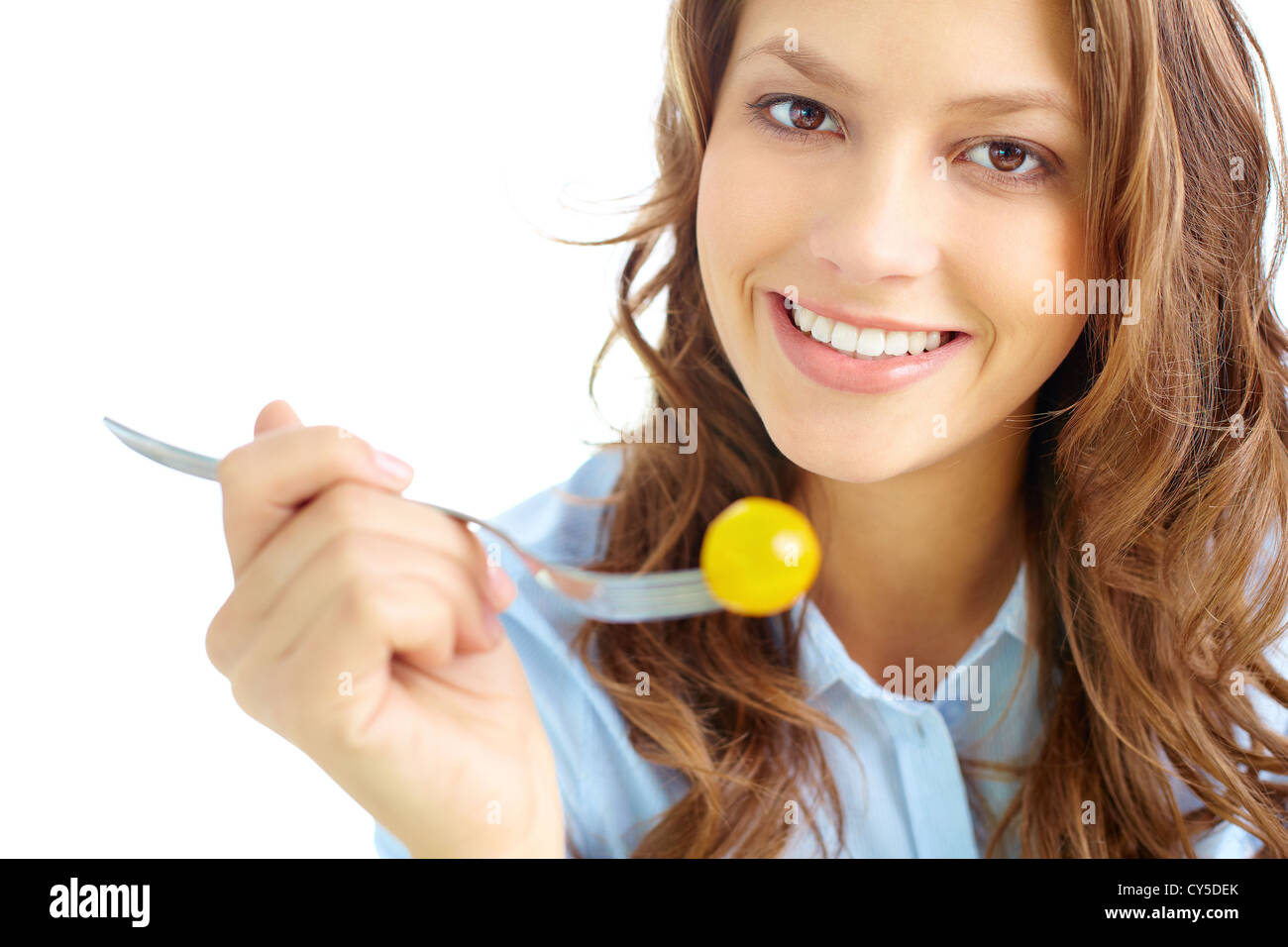Close-up of pretty girl holding fork with fresh cherry tomato Stock ...