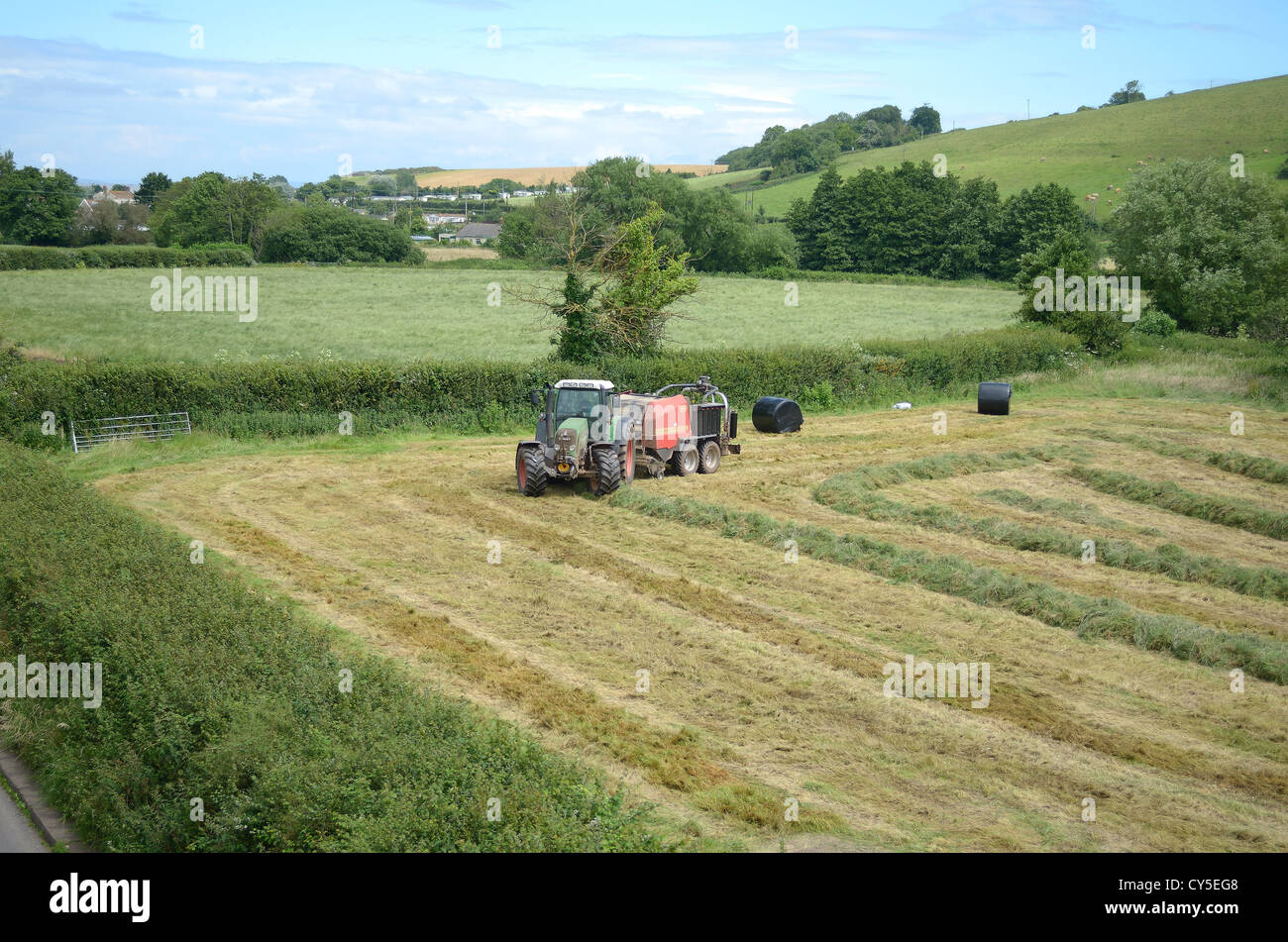 FARM TRACTOR BALING SILAGE IN THE UK Stock Photo - Alamy