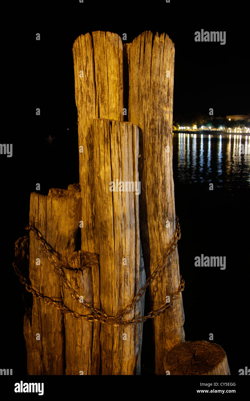 wooden boat mooring posts in lake at night Stock Photo - Alamy