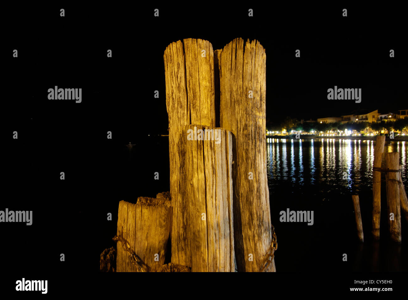 wooden boat mooring posts in lake at night Stock Photo - Alamy