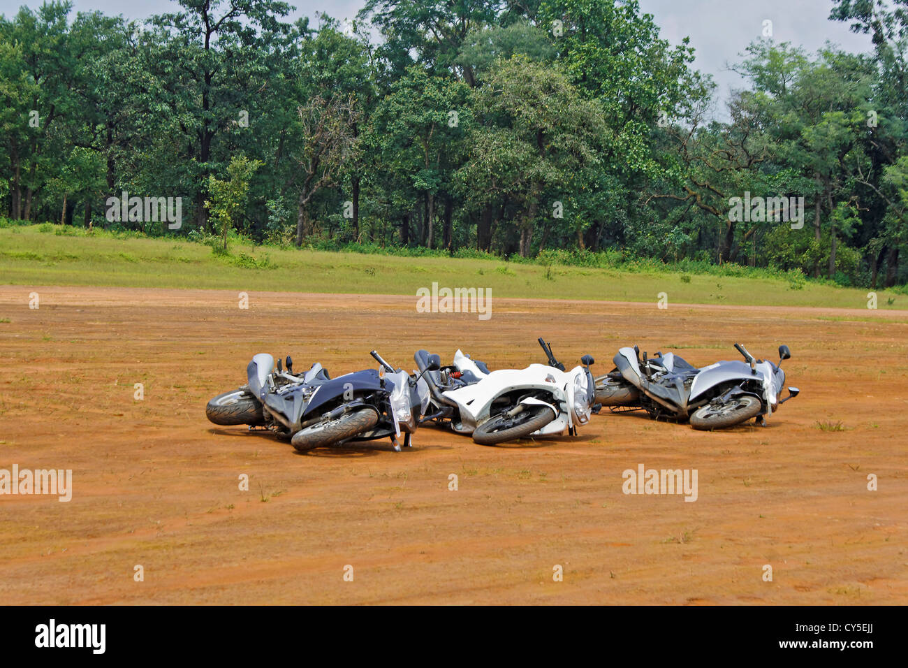 Three generic motorbikes dropped on their side. Concept, play dead they ...