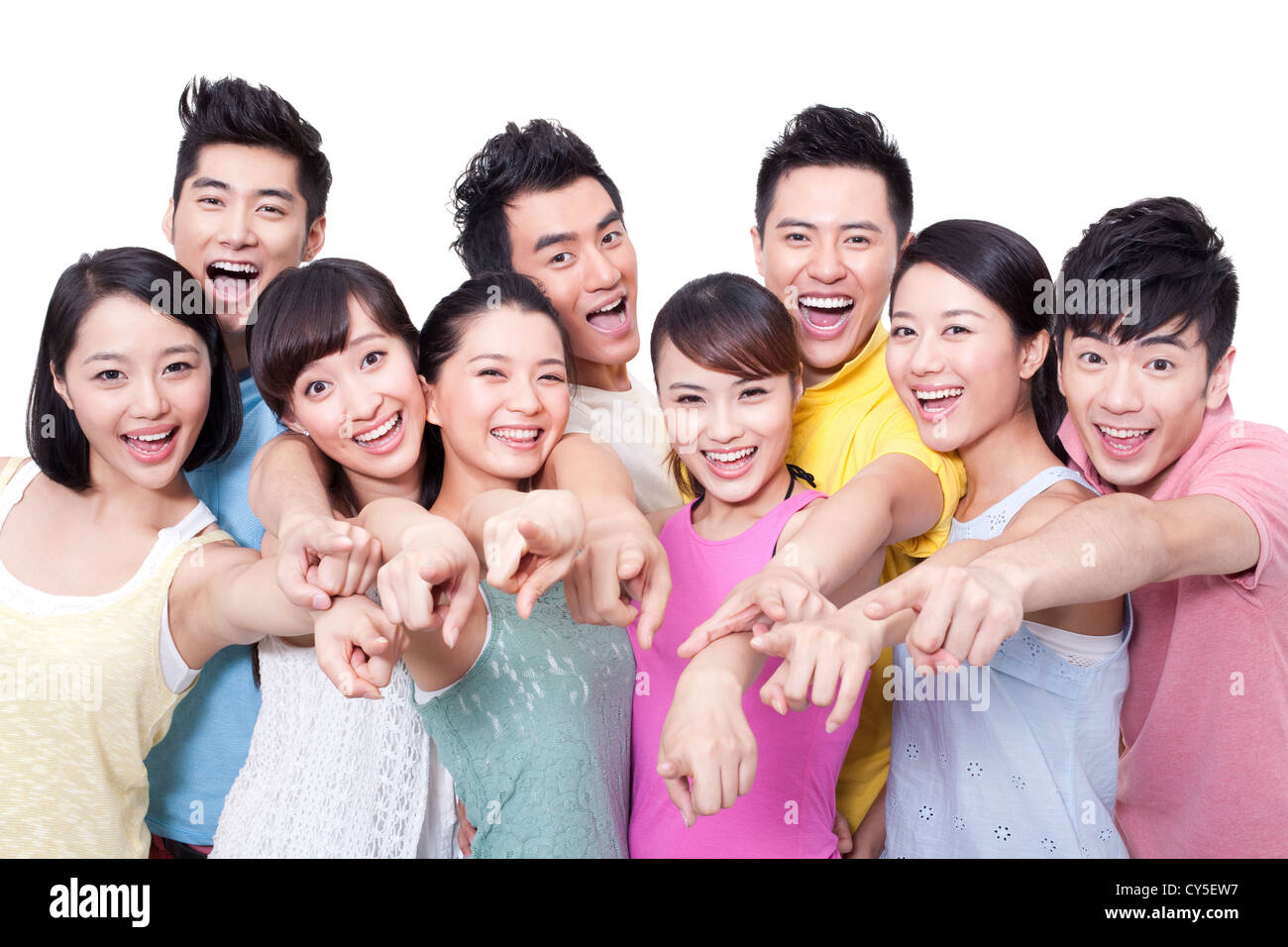 Happy young friends pointing the front Stock Photo - Alamy