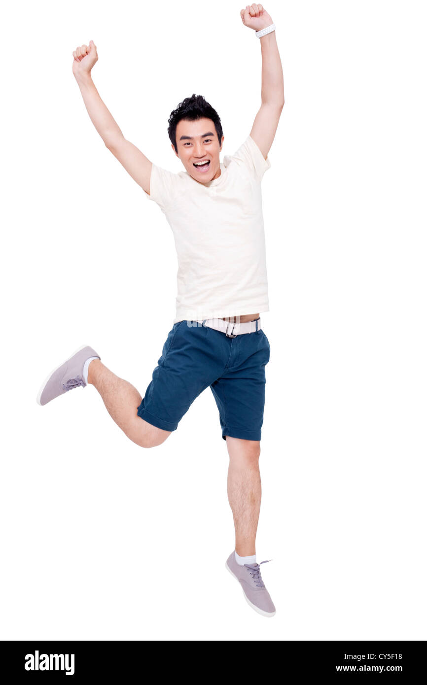 Cheerful young man jumping Stock Photo - Alamy