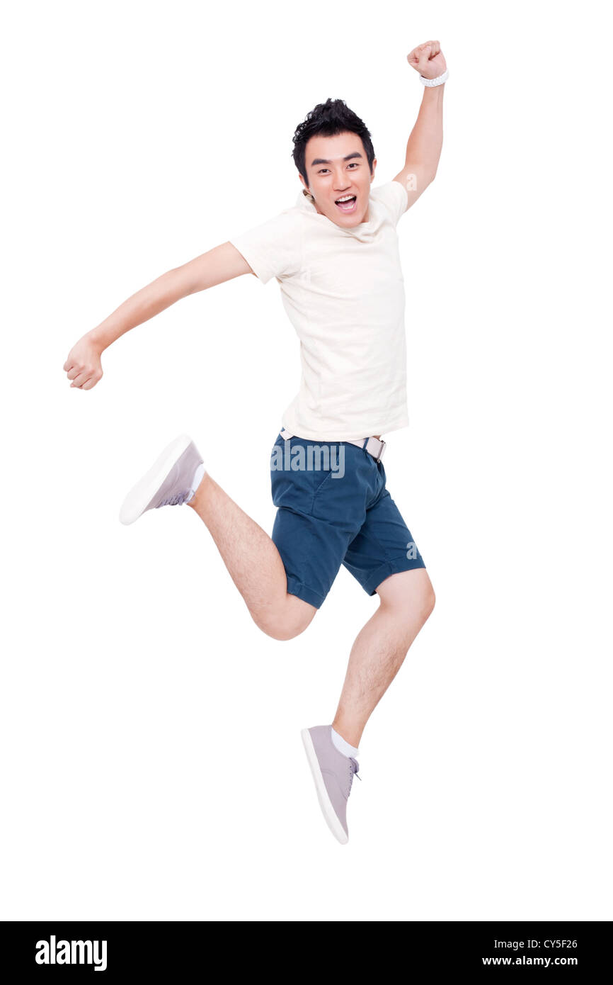 Cheerful young man jumping Stock Photo - Alamy