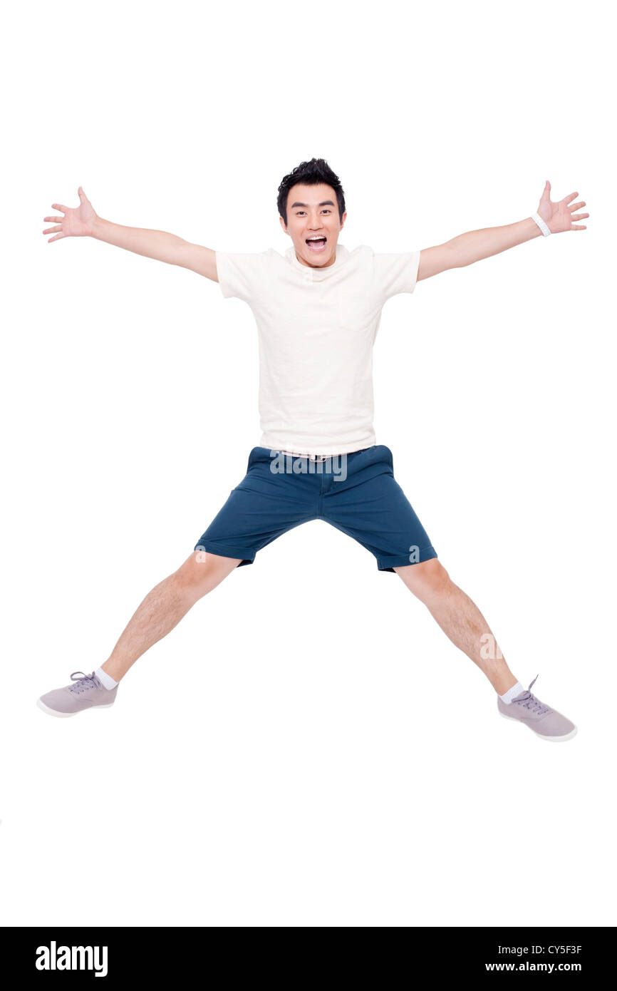 Cheerful young man jumping Stock Photo - Alamy