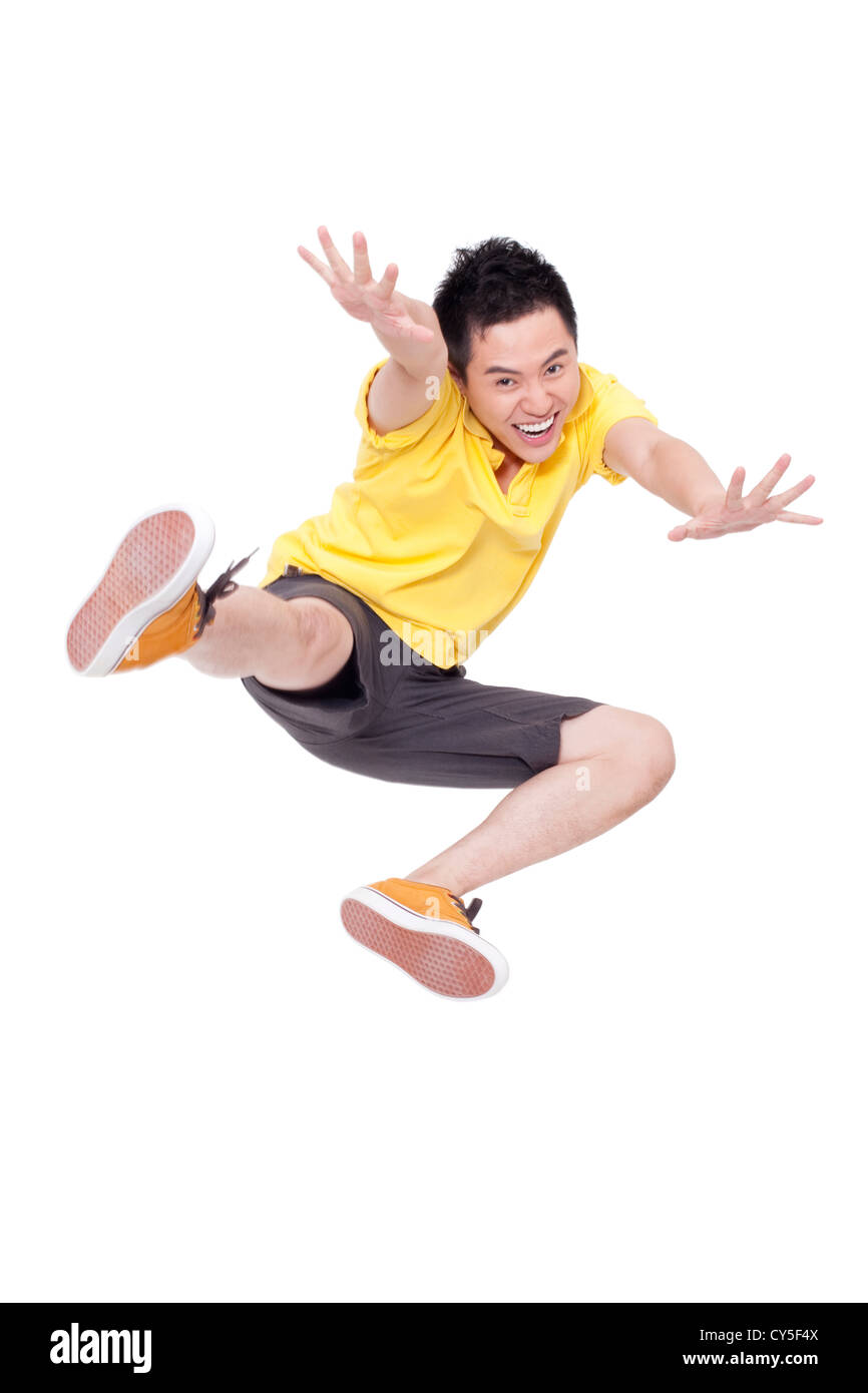 Cheerful young man jumping Stock Photo - Alamy