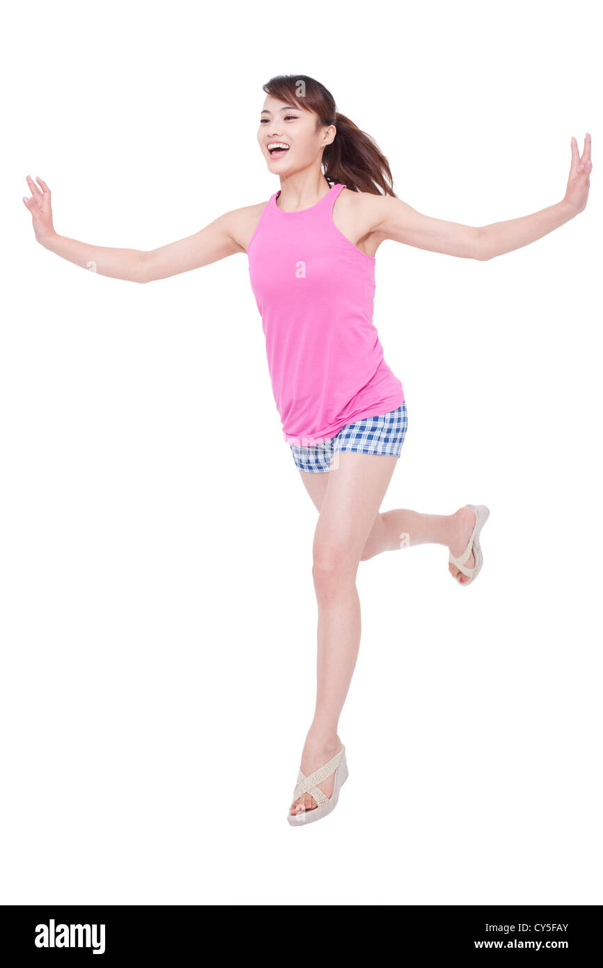 Cheerful young woman jumping Stock Photo - Alamy