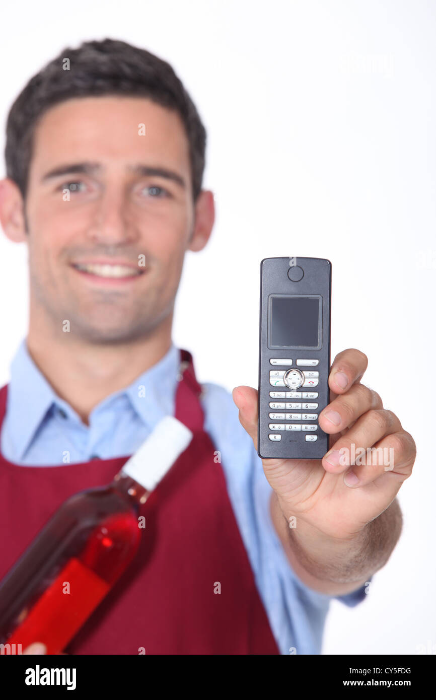 Waitor showing mobile phone Stock Photo - Alamy
