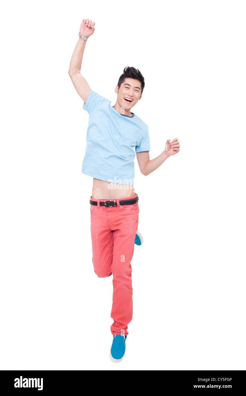Happy young man jumping Stock Photo - Alamy