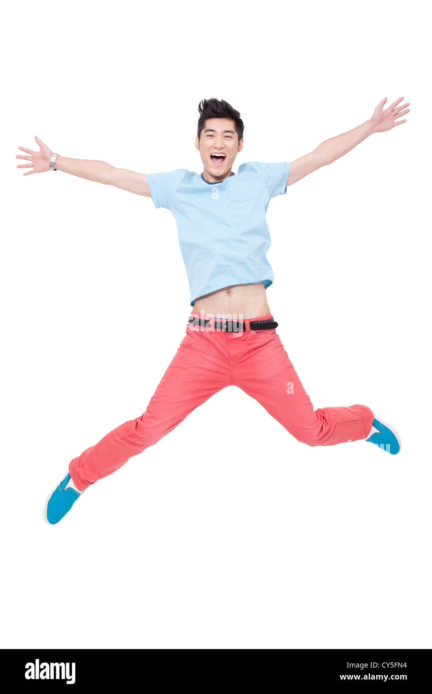 Happy young man jumping Stock Photo - Alamy