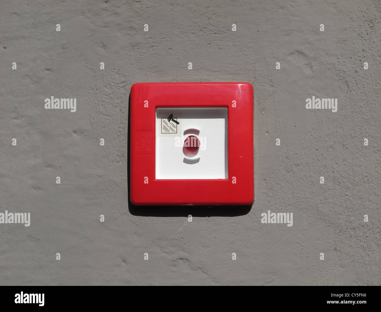 red emergency button on wall in sun Stock Photo - Alamy