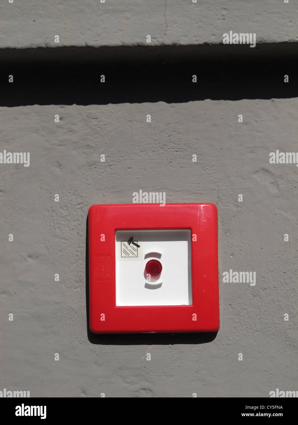 red emergency button on wall in sun Stock Photo - Alamy