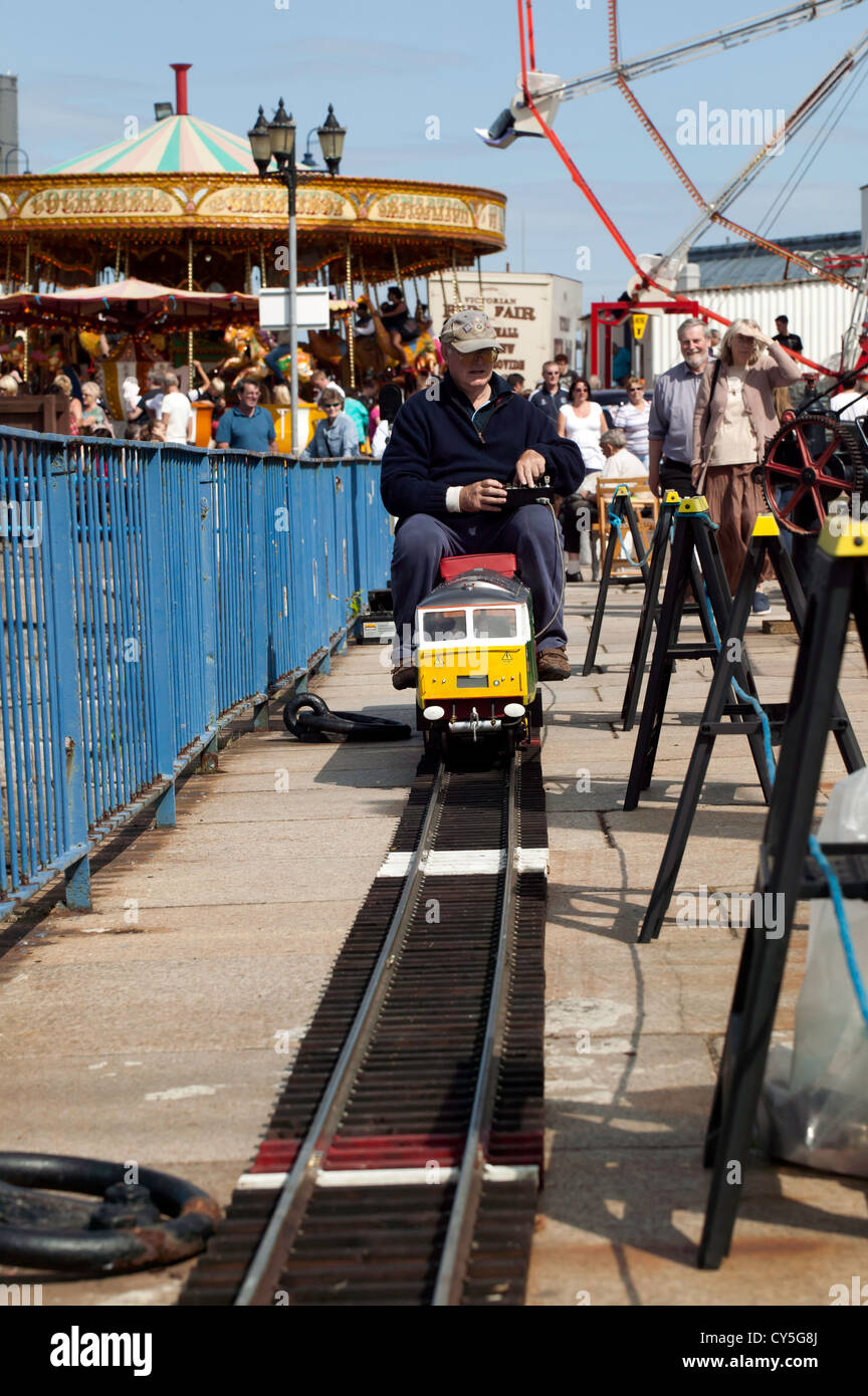 Small scale, ride-on model railway giving rides to people at the ...