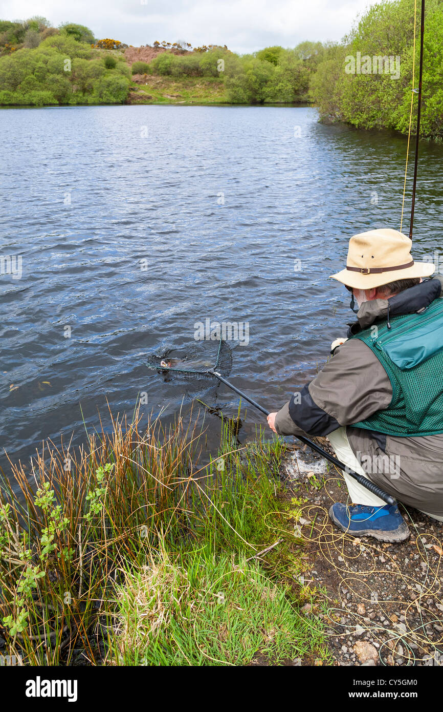 Angler netting fish hi-res stock photography and images - Alamy