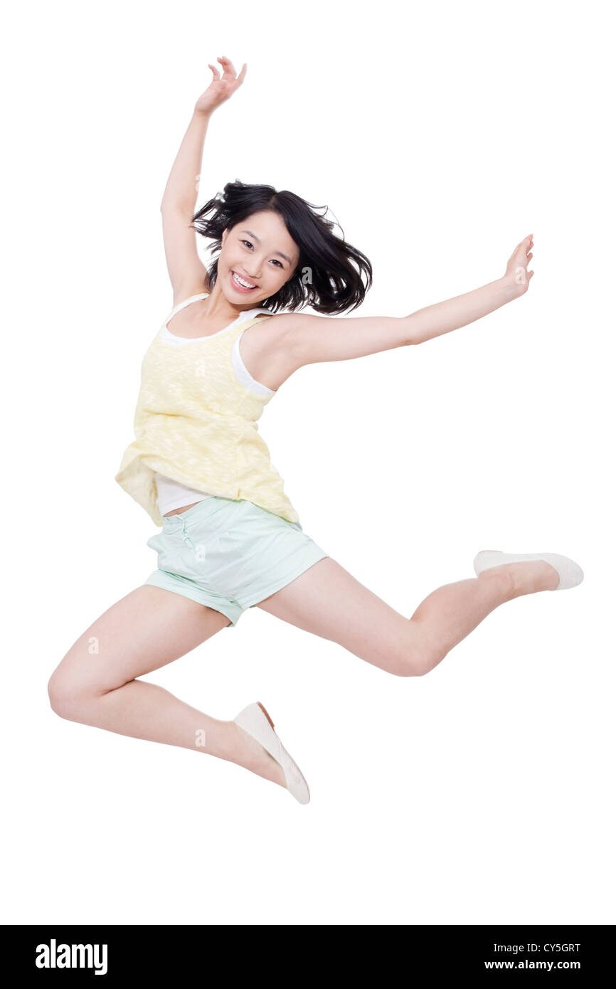 Happy young woman jumping Stock Photo - Alamy