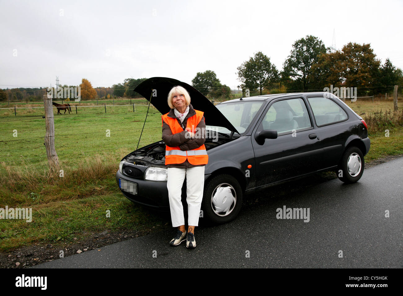 Senior woman has car breakdown Stock Photo - Alamy